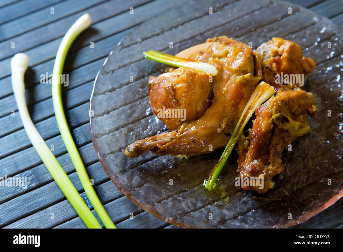 Fried rabbit cooked with lemon sauce and young garlic Stock Photo - Alamy