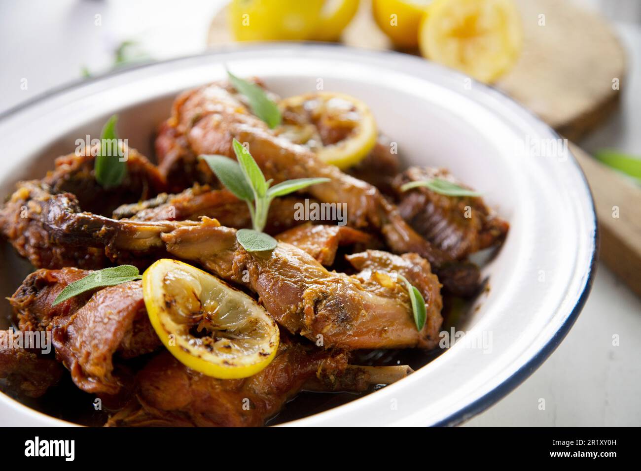 Fried rabbit cooked with lemon and sage sauce Stock Photo - Alamy