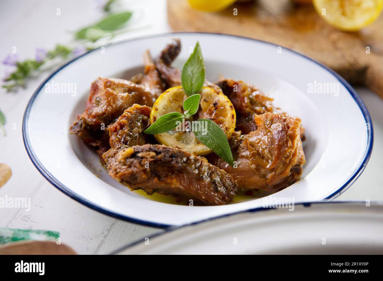 Fried rabbit cooked with lemon and sage sauce Stock Photo - Alamy