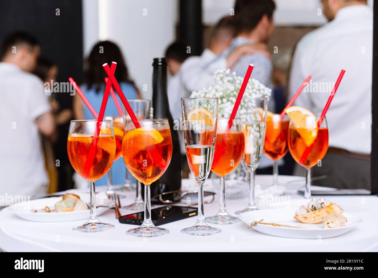 A group of people gathered behind a buffet table, celebrating with ...