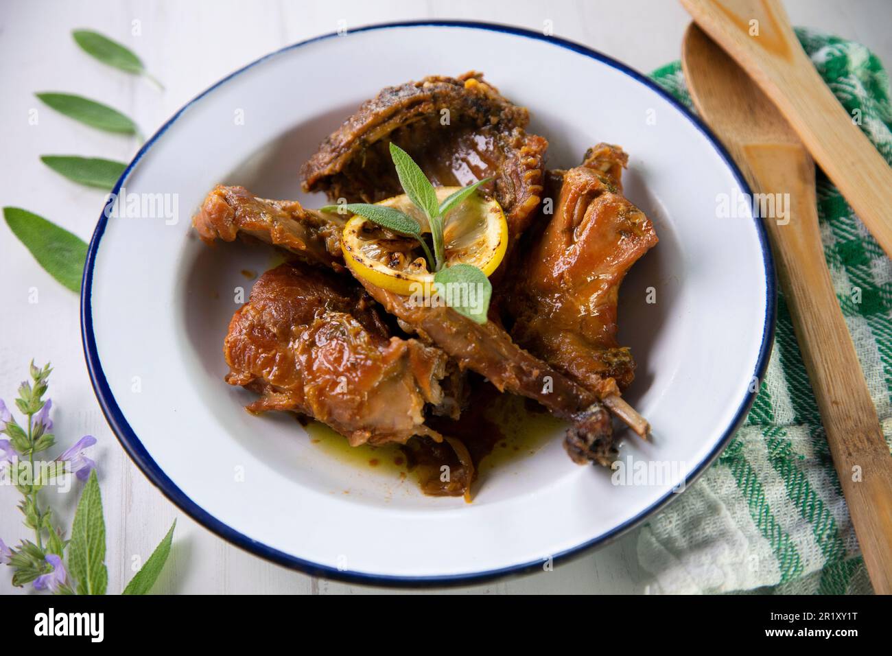 Fried rabbit cooked with lemon and sage sauce Stock Photo - Alamy