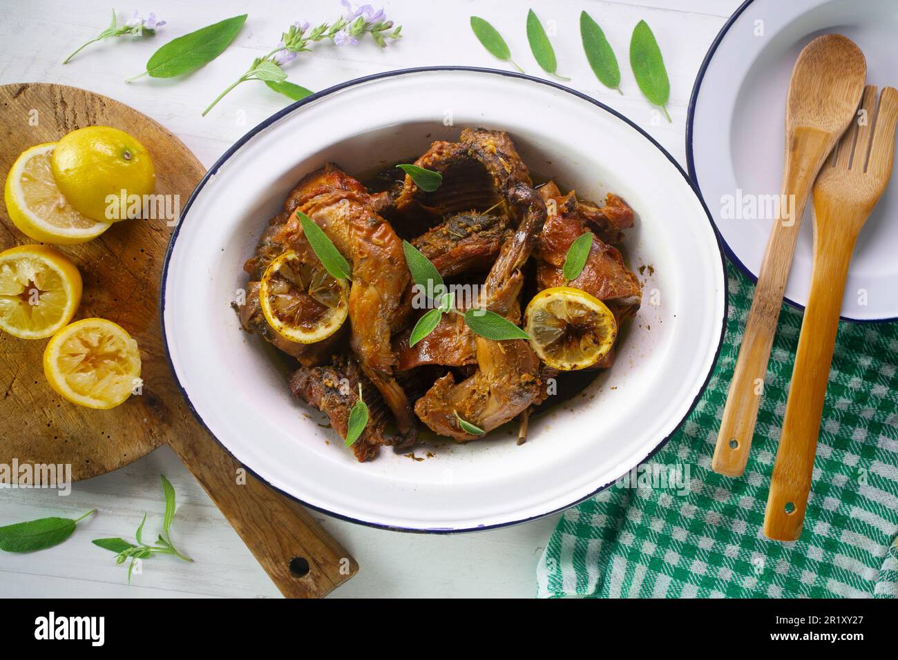 Fried rabbit cooked with lemon and sage sauce Stock Photo - Alamy