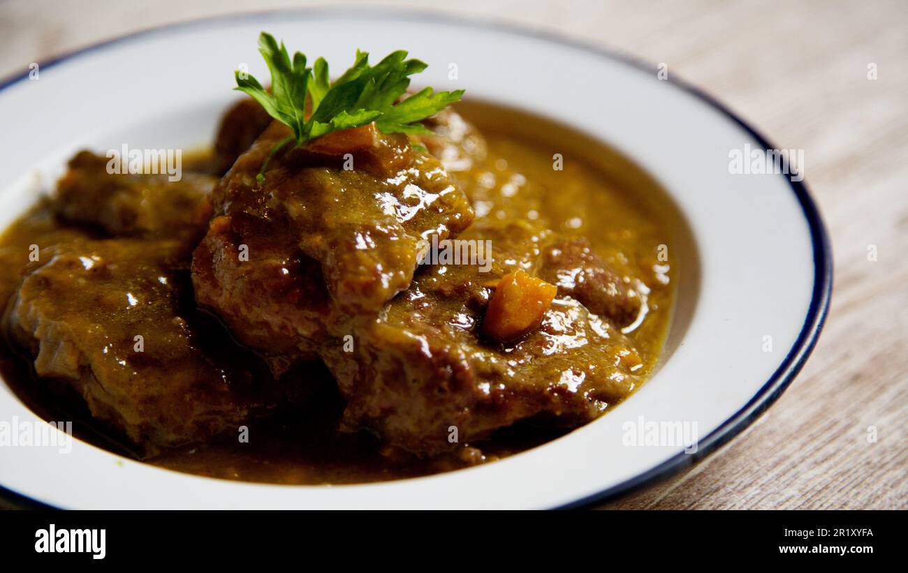 Stewed cheek with sauce. Traditional Spanish tapa recipe Stock Photo ...
