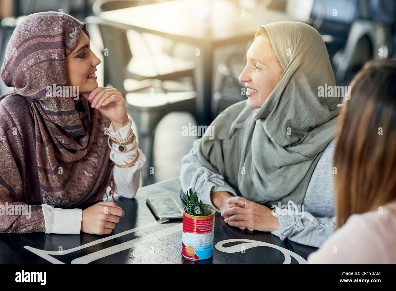 Smile, friends and Muslim women in coffee shop, bonding and talking ...