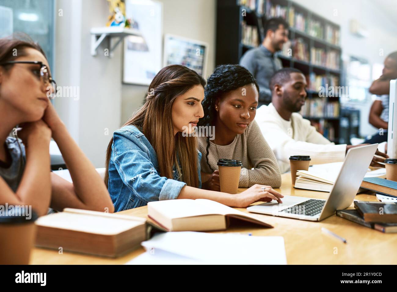 Laptop, library and university girl students studying together for ...