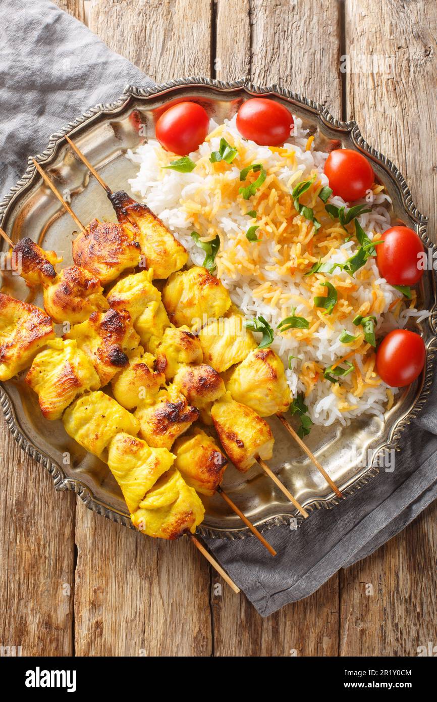 Joojeh kabab is a classic Persian chicken kebob with rice closeup on ...