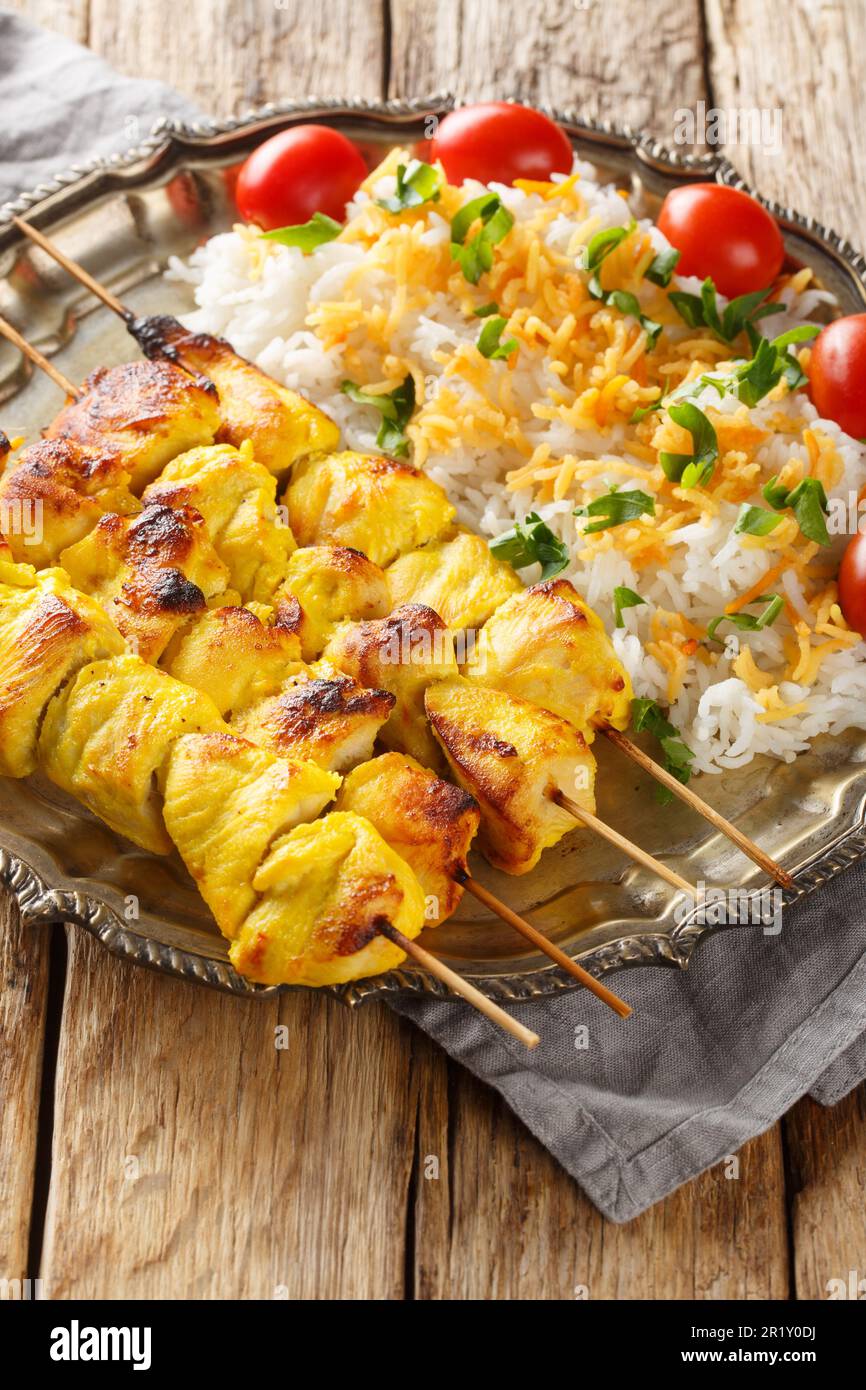 Joojeh kabab is a classic Persian chicken kebob with rice closeup on ...