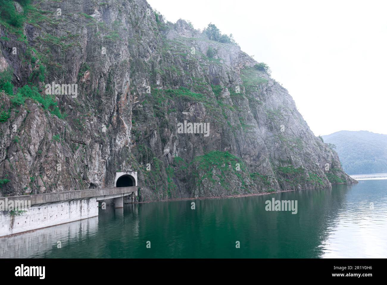Vidraru Dam Lake in Romania . Foggy scenery with mountains and lake ...