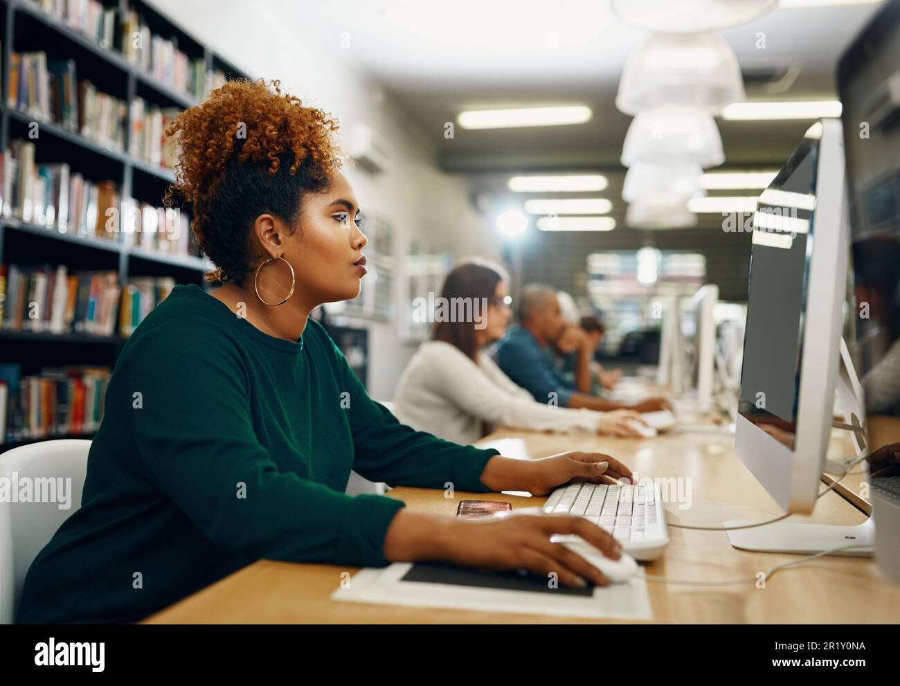 College, woman and computer in library for learning, education and ...