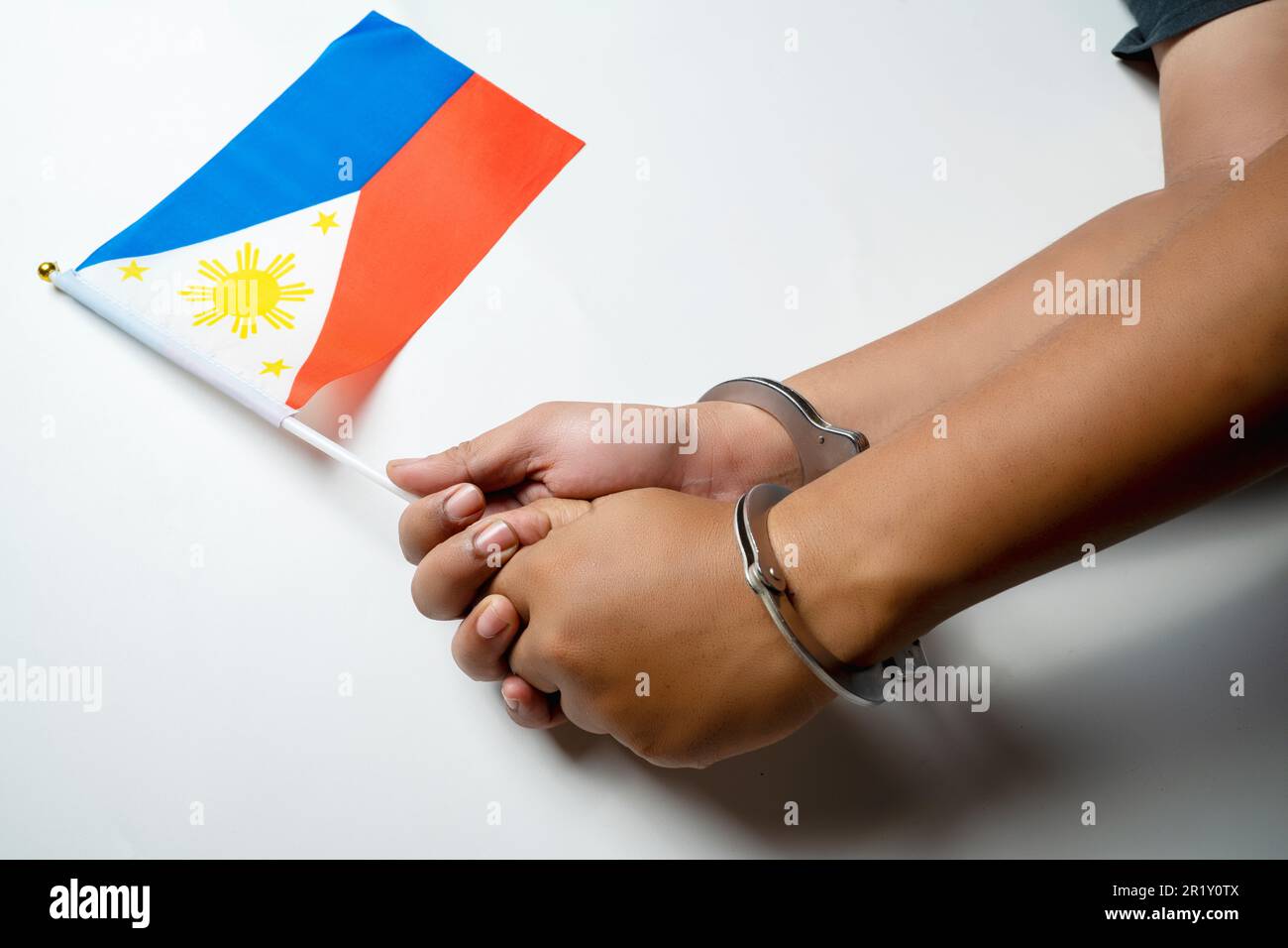 Human hand in handcuff with Philippines national flag on white ...
