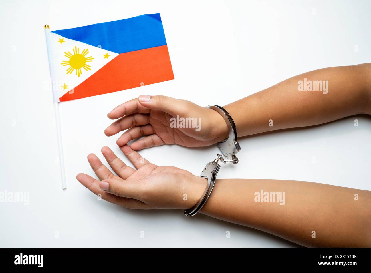 Human hand in handcuff with Philippines national flag on white ...