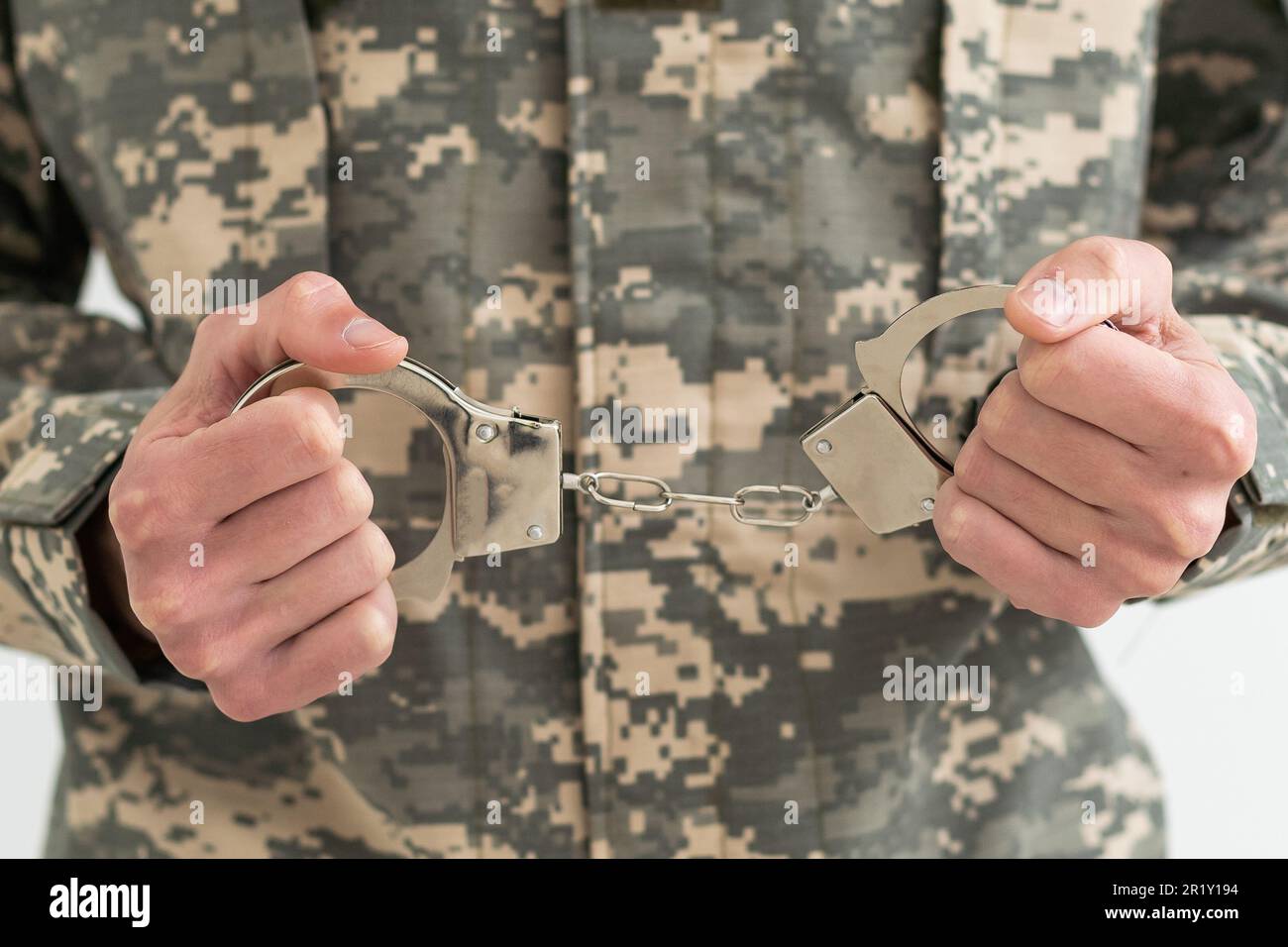 a military man is holding handcuffs Stock Photo - Alamy