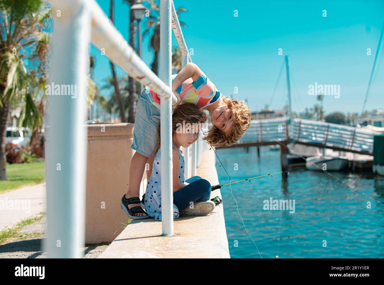 Two kids funny boy and girl fishing in lake. Happy children friends ...
