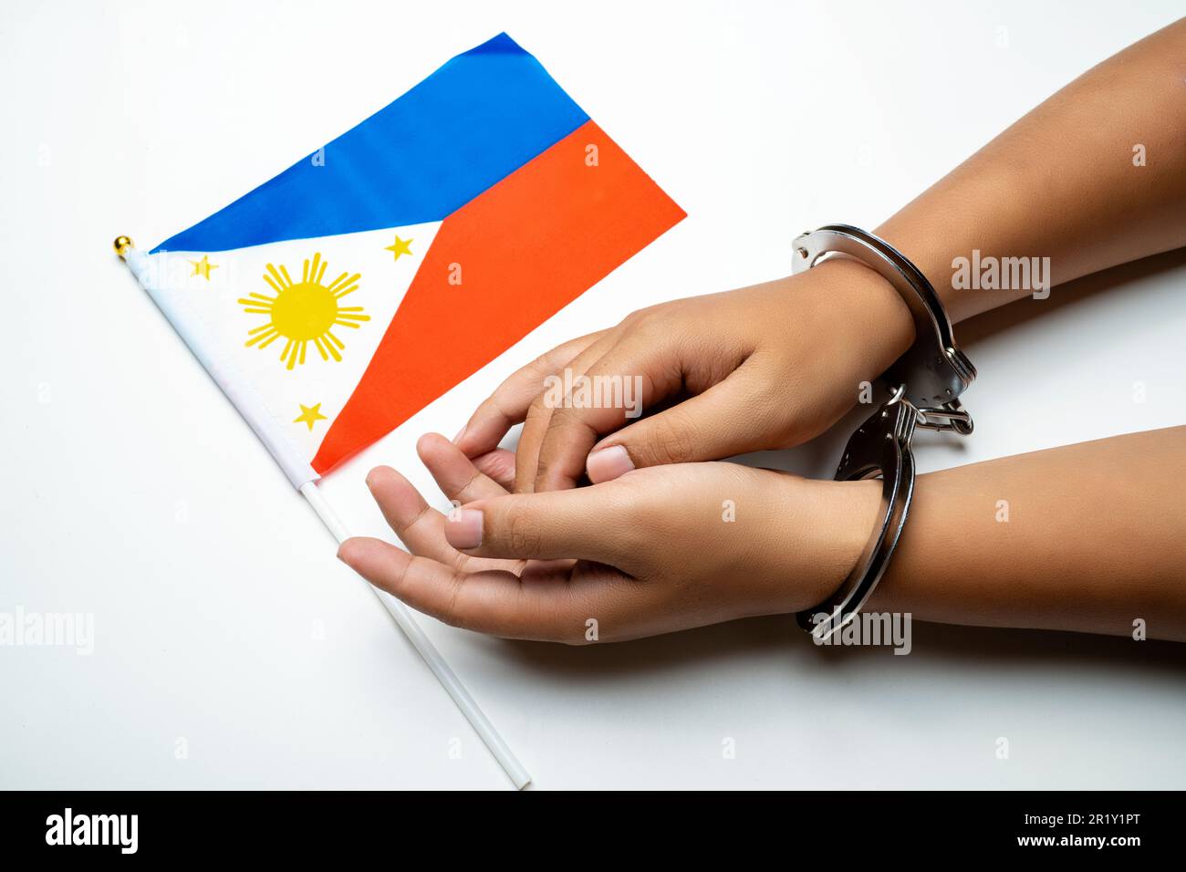 Human hand in handcuff with Philippines national flag on white ...
