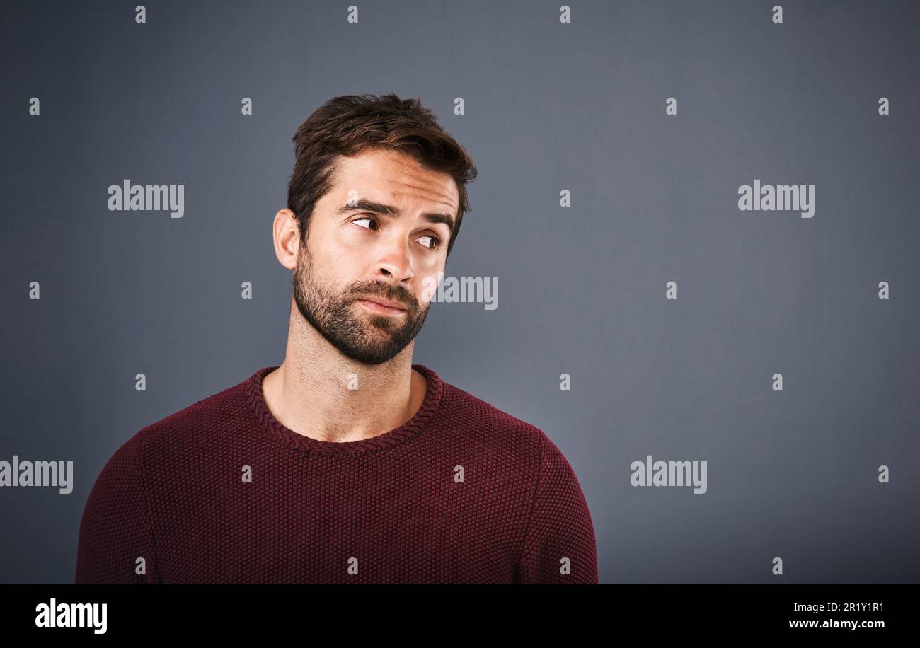 Doubt, thinking and face of unsure man in studio with worry, uncertain ...