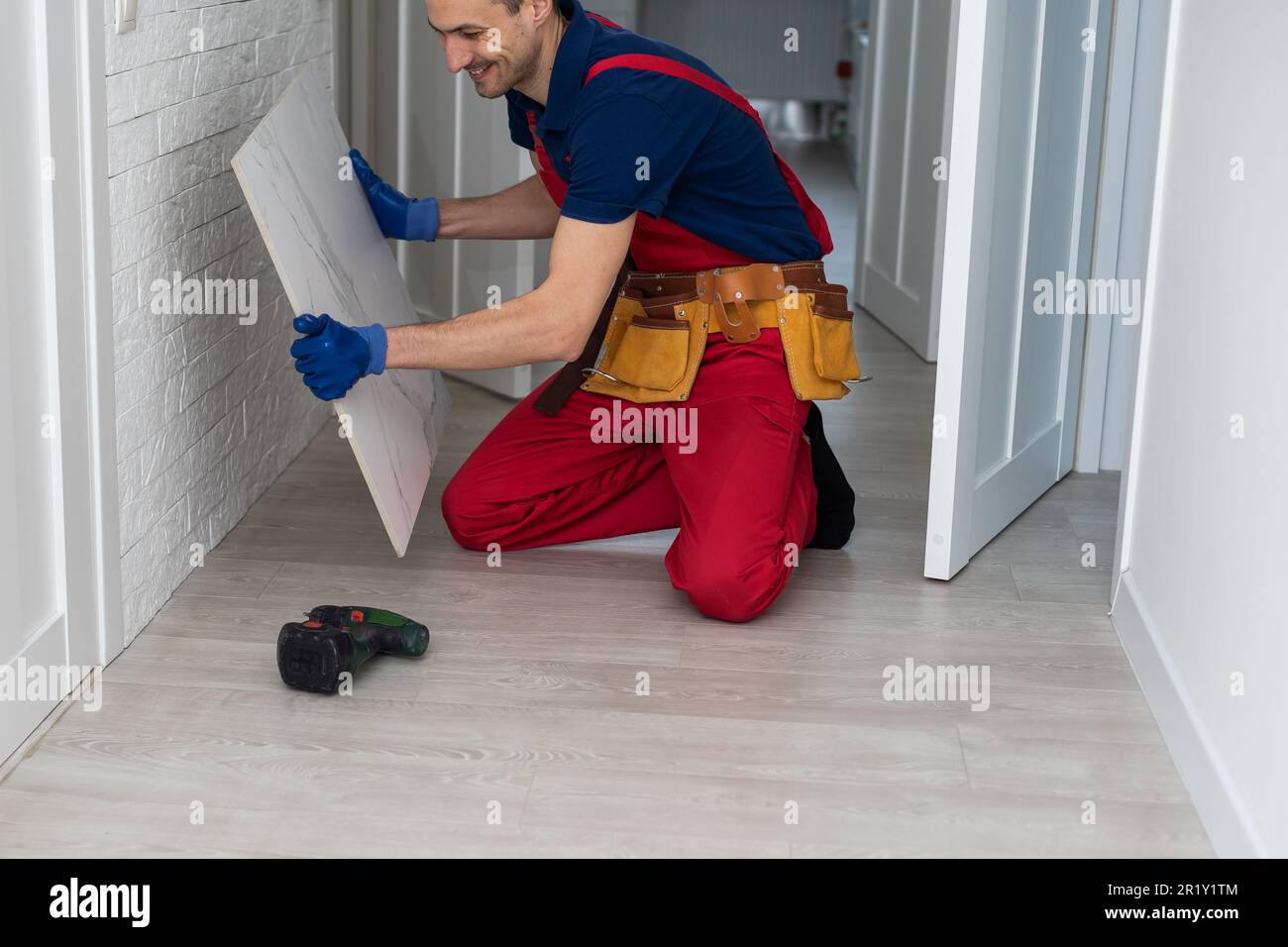 Home improvement, renovation - construction worker tiler is tiling ...