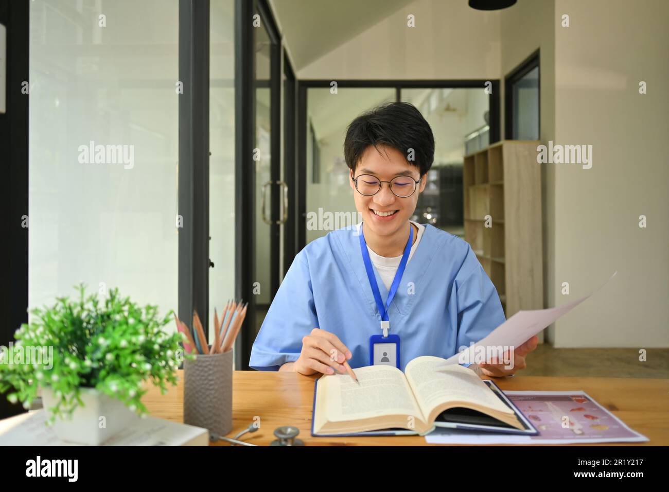 Medical student reading books, preparing for university exams in ...