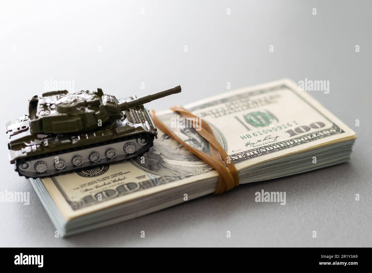 toy tank on the background of dollar bills Stock Photo - Alamy