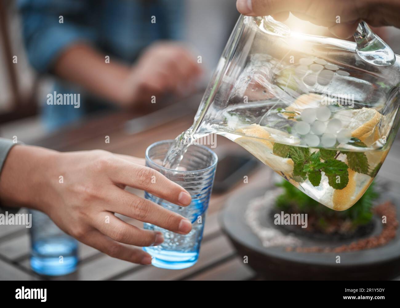 Hands, closeup and water into a glass, outdoor and social gathering ...