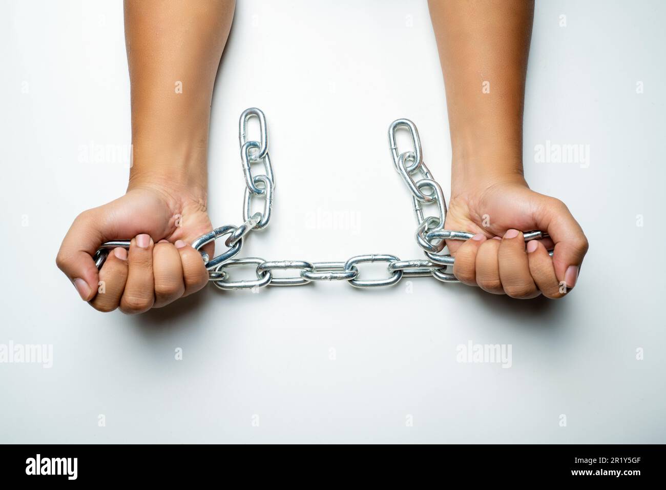 Humans hand holding a chain of metal steel with white background Stock ...