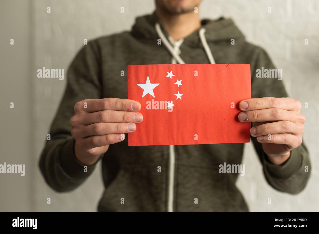hand holding Chinese flag isolated on white background, template for ...