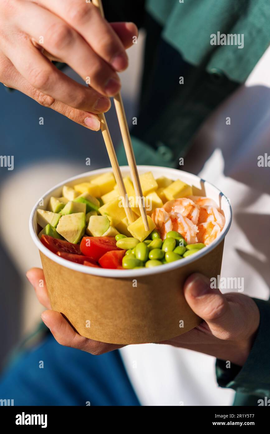 View woman eating poke bowl hi-res stock photography and images - Alamy