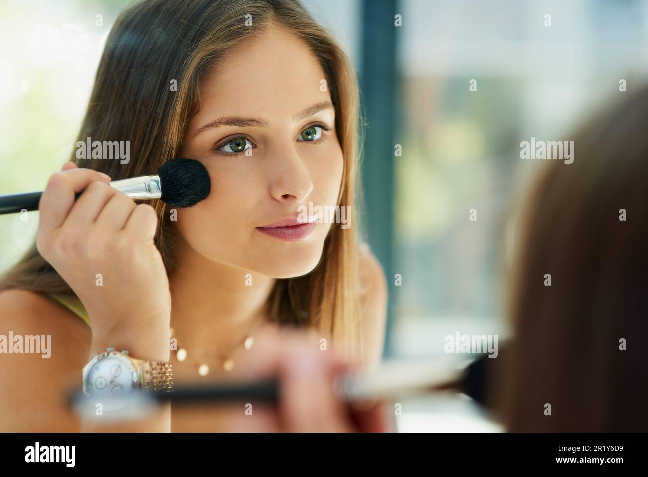 Mirror, makeup and blusher with a woman in the bathroom to apply ...