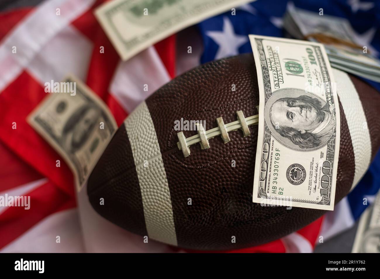 American football rugby ball and dollars on usa flag. Sports game Stock ...