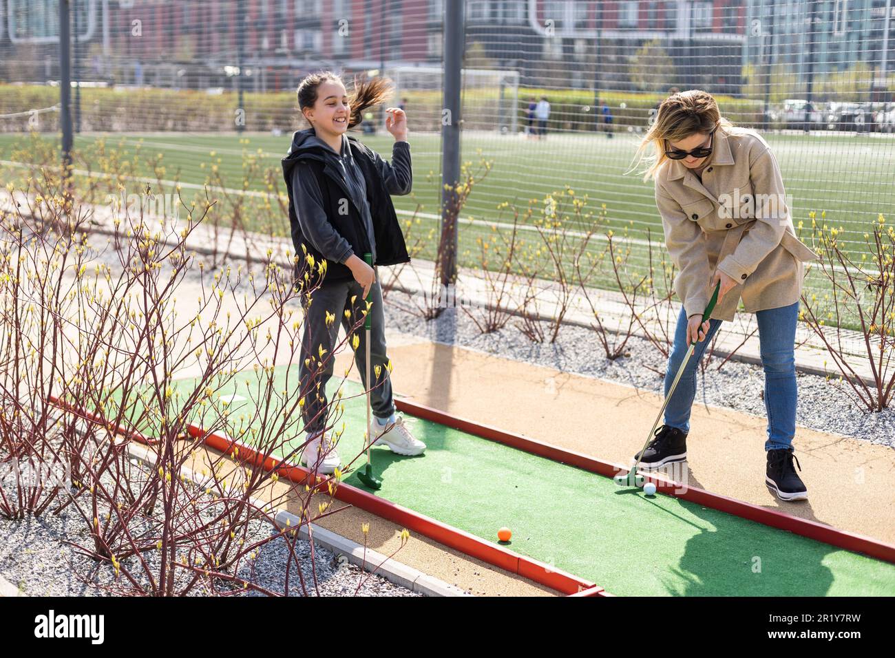 Family Time Playing Mini-Golf In The Summer Stock Photo - Alamy