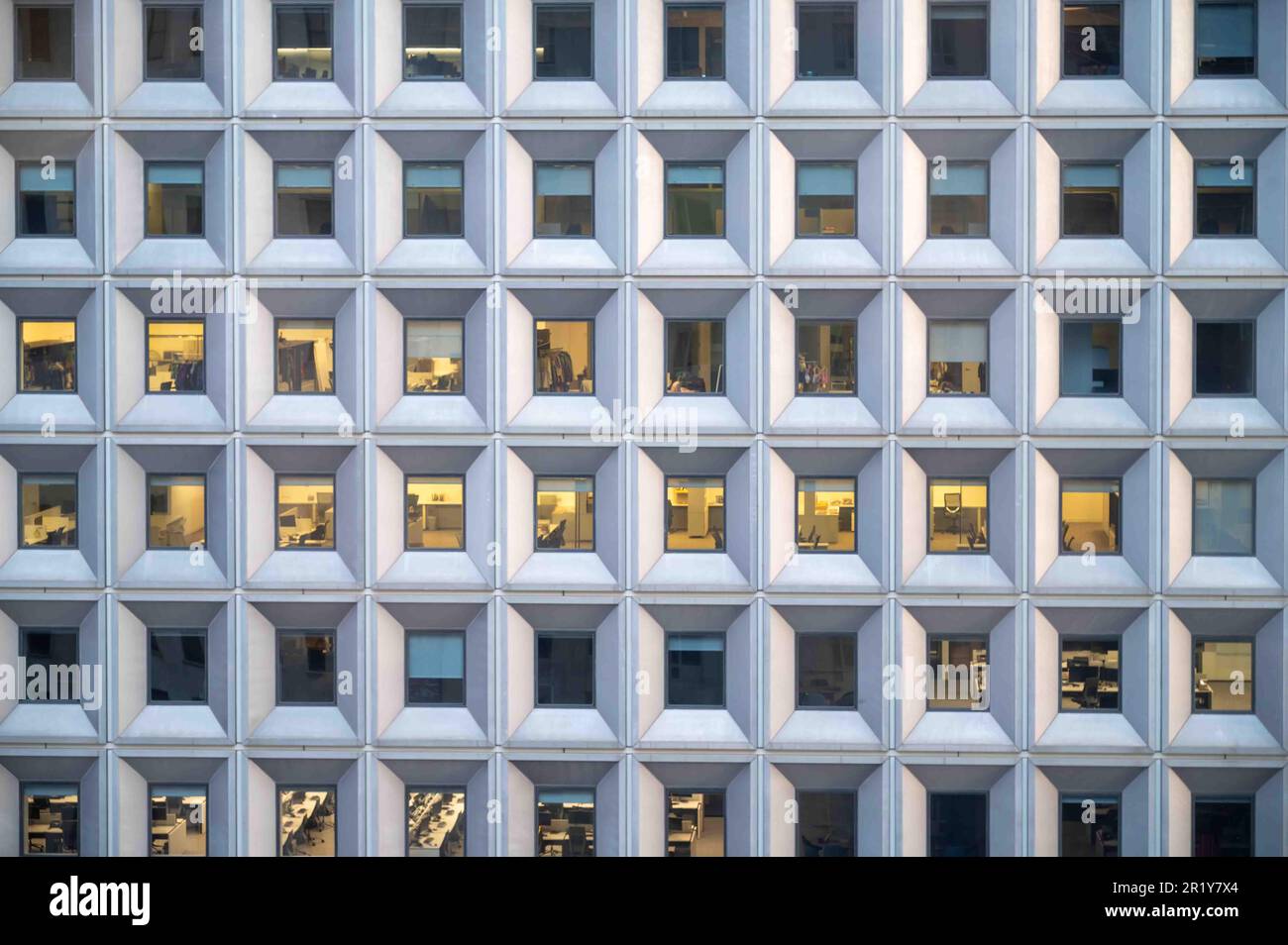 Facade of urban skyscraper with rows of square geometric windows Stock ...