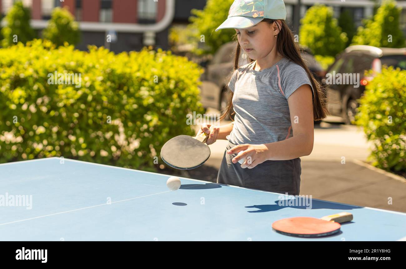 Cute girl playing table tennis hi-res stock photography and images - Alamy