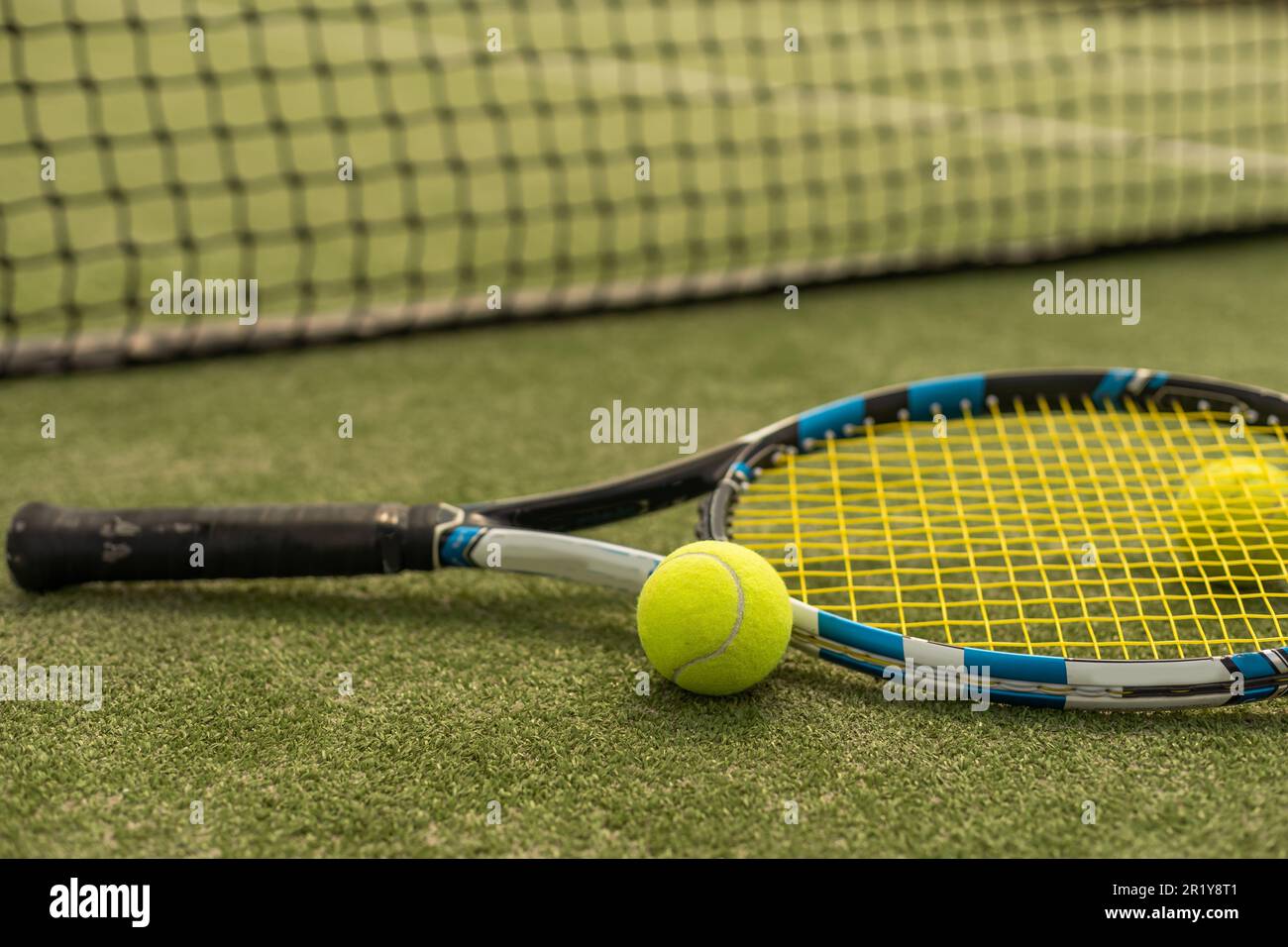 tennis racket with a tennis ball on a tennis court Stock Photo - Alamy
