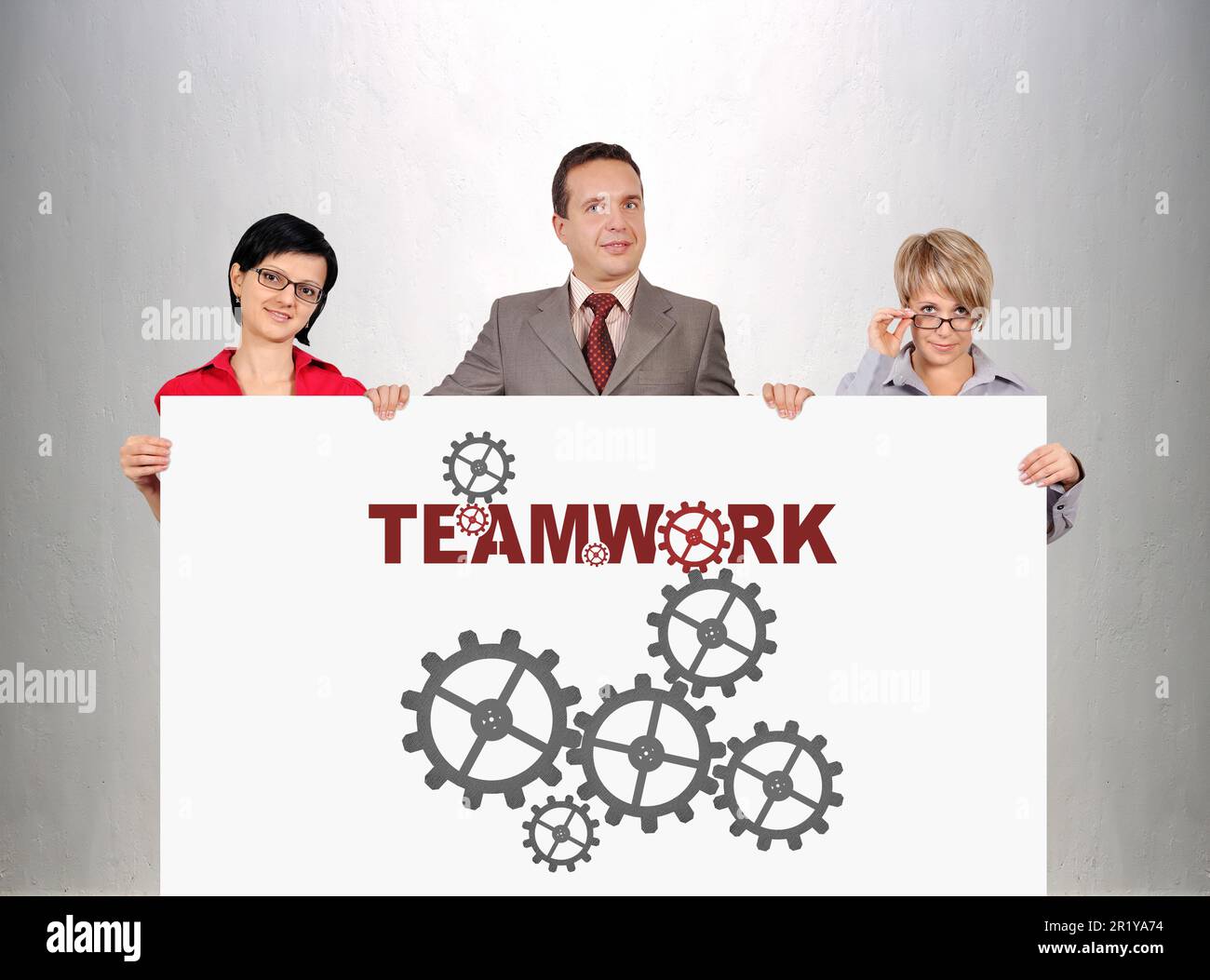 businesspeople holding poster with teamwork concept Stock Photo - Alamy