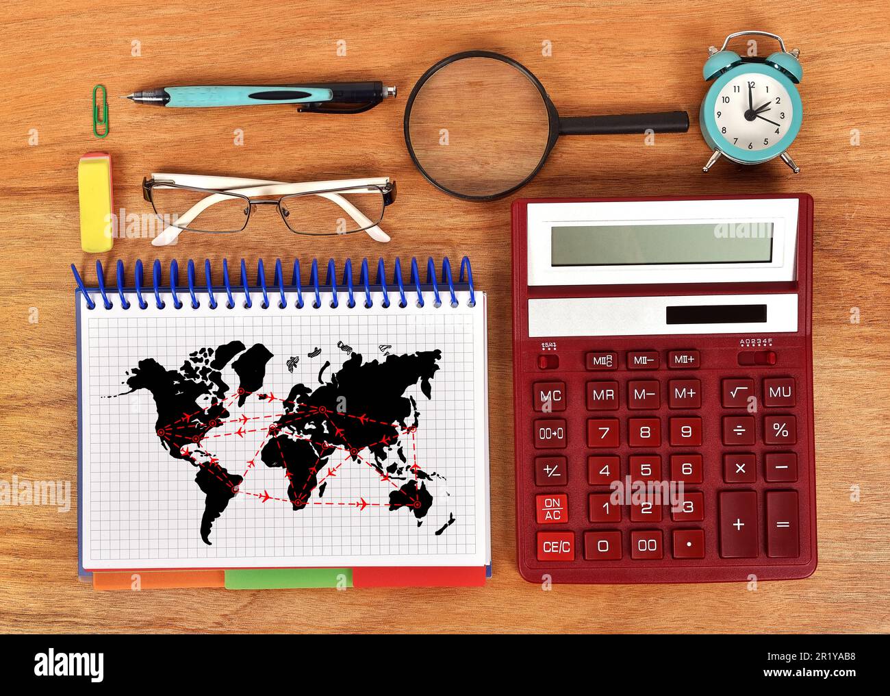 air travel scheme diagram in notebook, red calculator and business ...