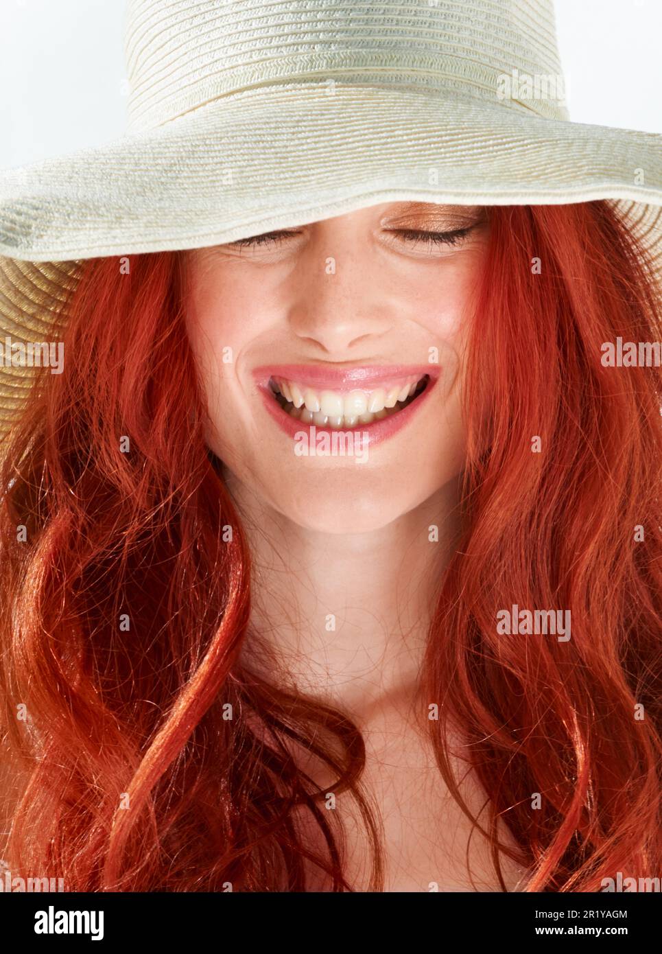 Happy woman, face and ginger or red hair with straw hat in studio ...