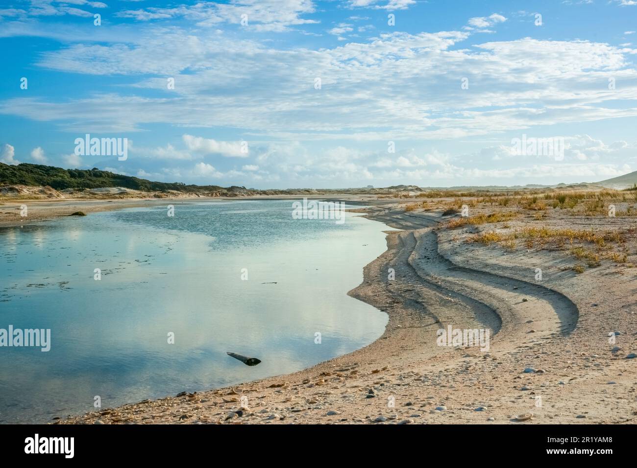 Stream running through dunes leading to waterfront Stock Photo - Alamy