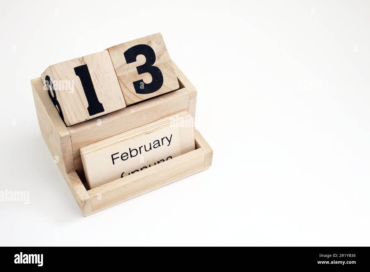 Wooden perpetual calendar showing the 13th of February Stock Photo - Alamy