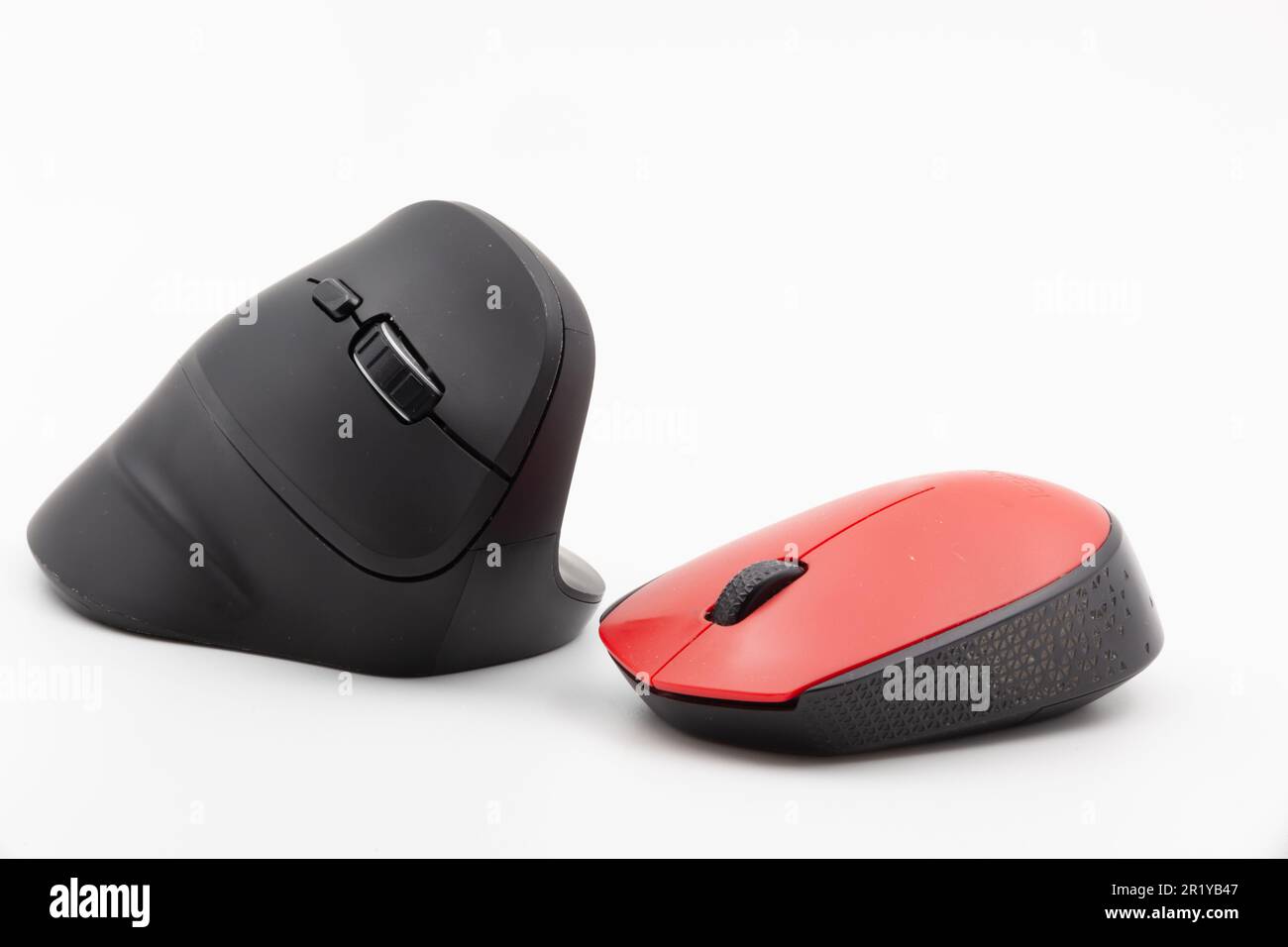 Vertical black and horizontal red computer mouse on a white background ...