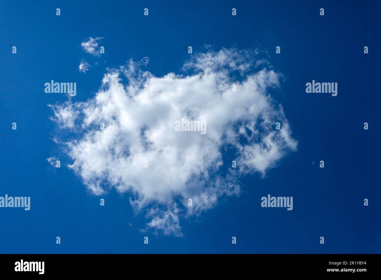 A single white cloud in an intensely blue sky, spring day Stock Photo ...