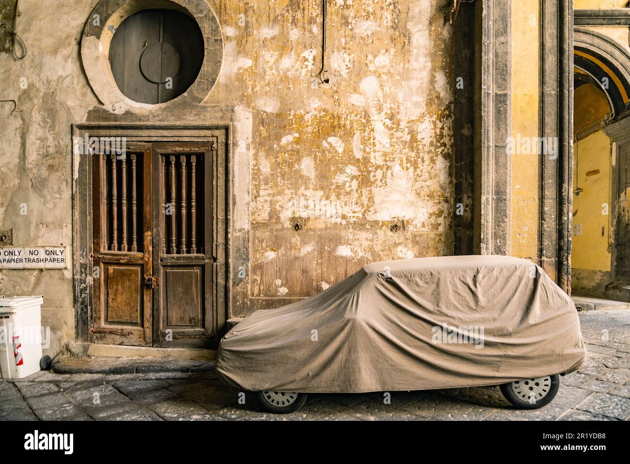 A covered car inside an historical building in Naples Stock Photo - Alamy