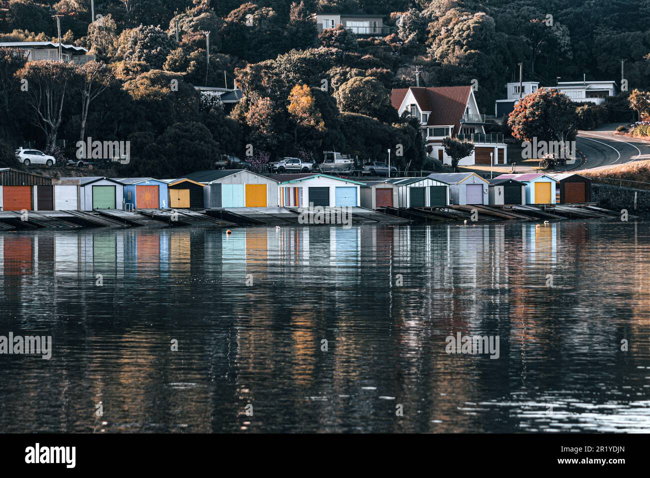 A cluster of brightly-colored homes reflected in the lake Stock Photo ...