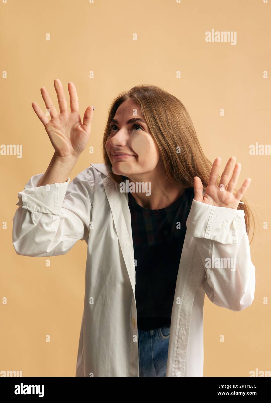 Portrait with one beautiful girl, woman wearing casual clothes putting ...