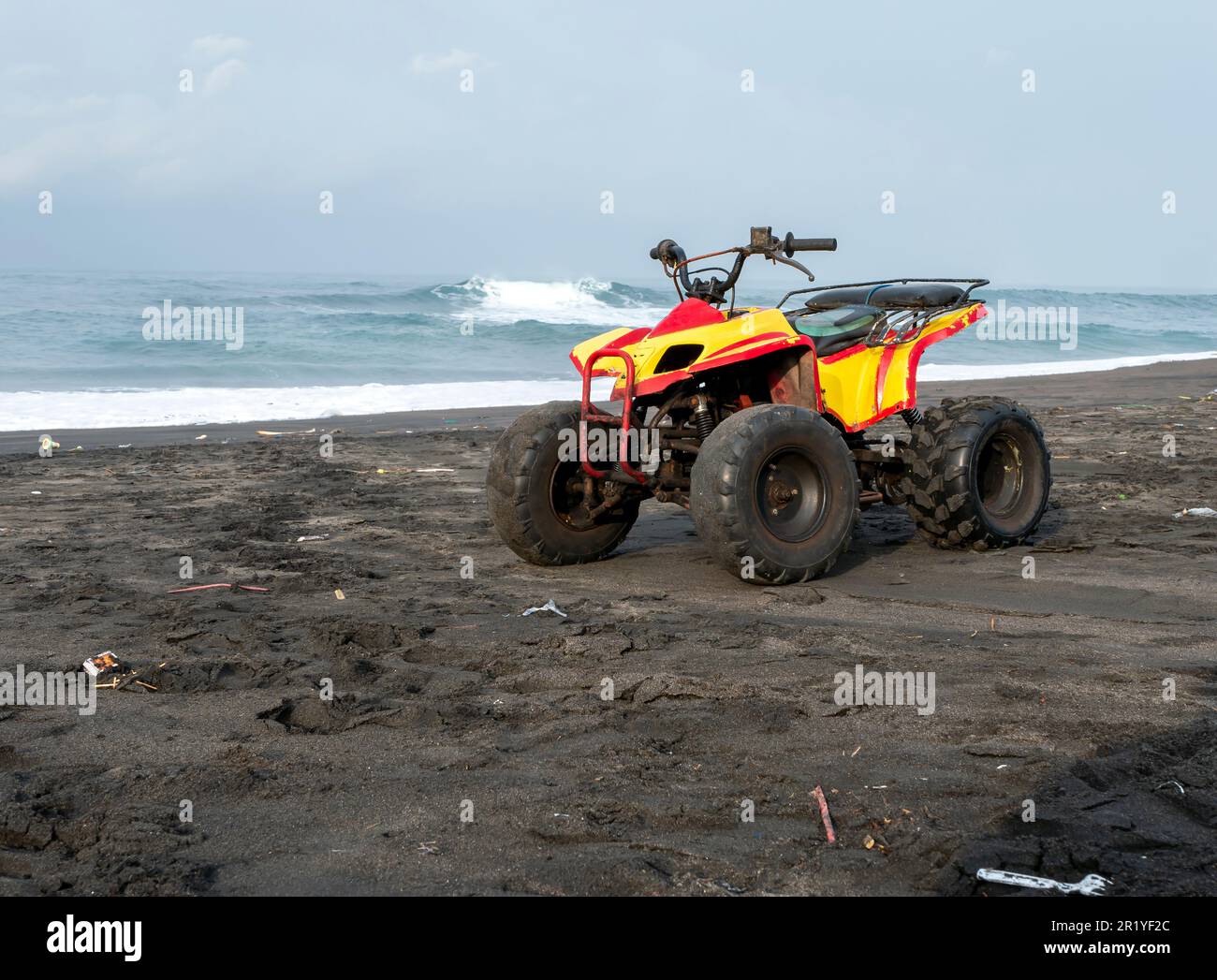 A yellow all-terrain vehicle (ATV), also known as a light utility ...