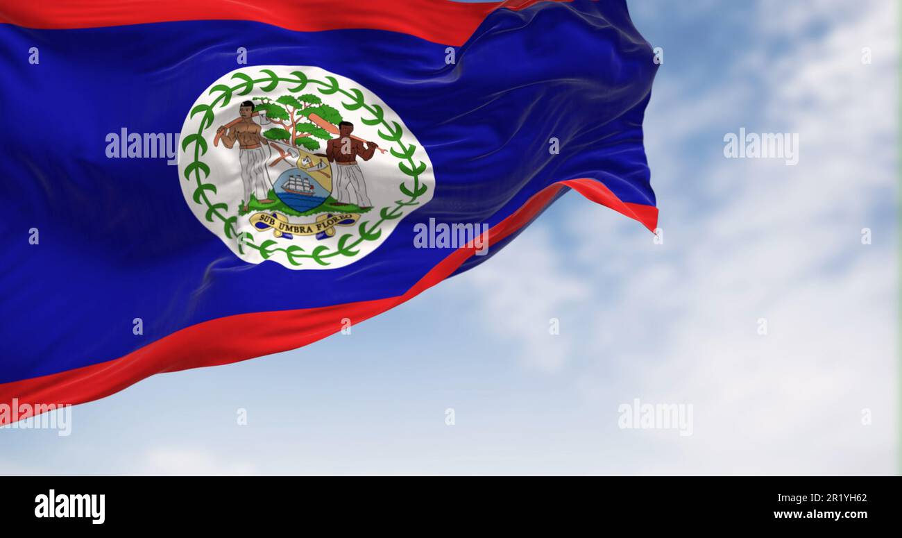 Belize national flag waving in the wind on a clear day. Blue field, red ...