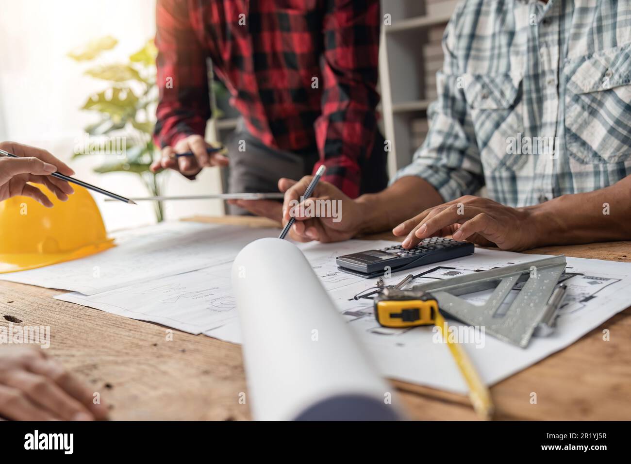 engineer working in office with blueprints, inspection in workplace for ...