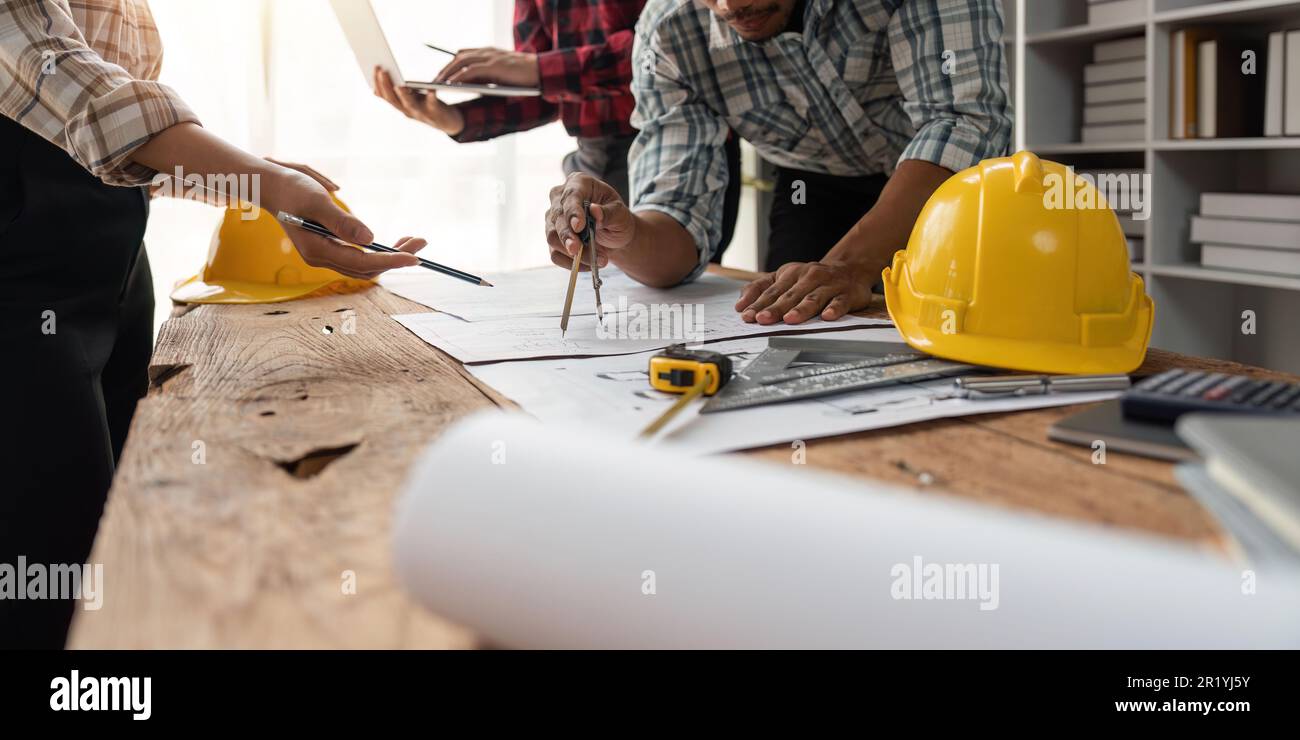 engineer working in office with blueprints, inspection in workplace for ...