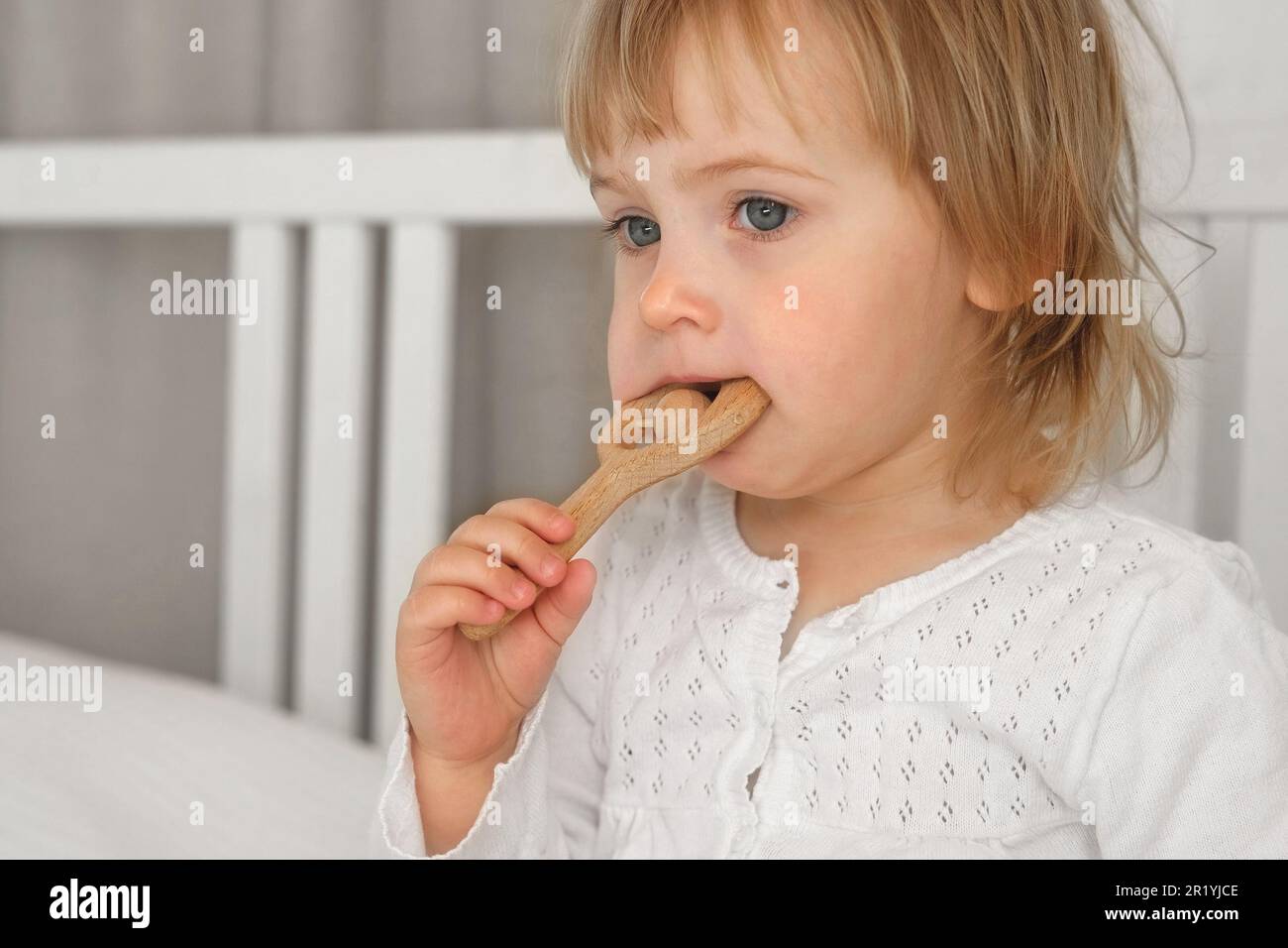 Cute baby girl playing tactile wooden and silicone toys. Young child ...