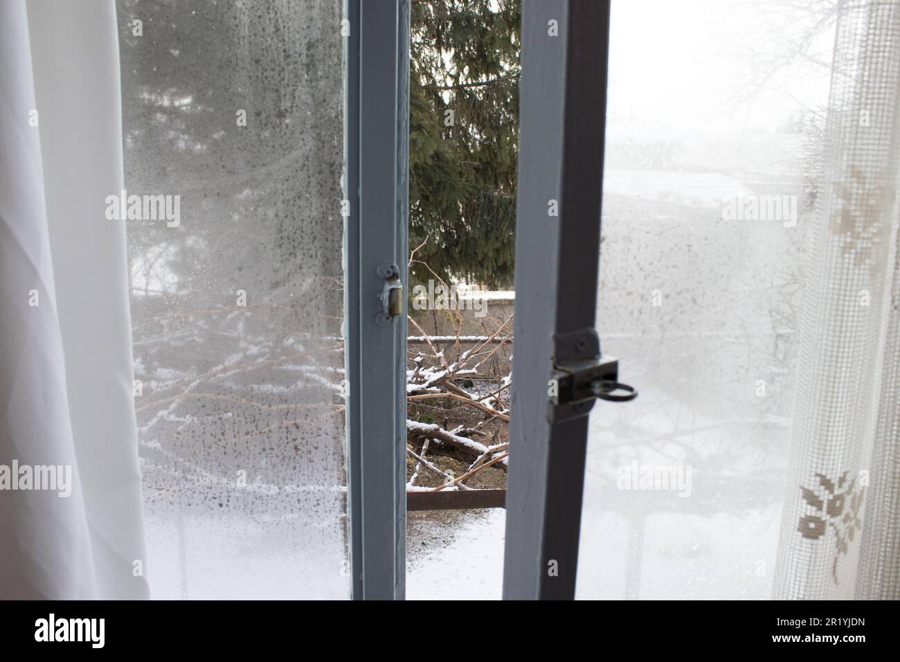 The snow-covered backyard, viewed through the foggy window Stock Photo ...