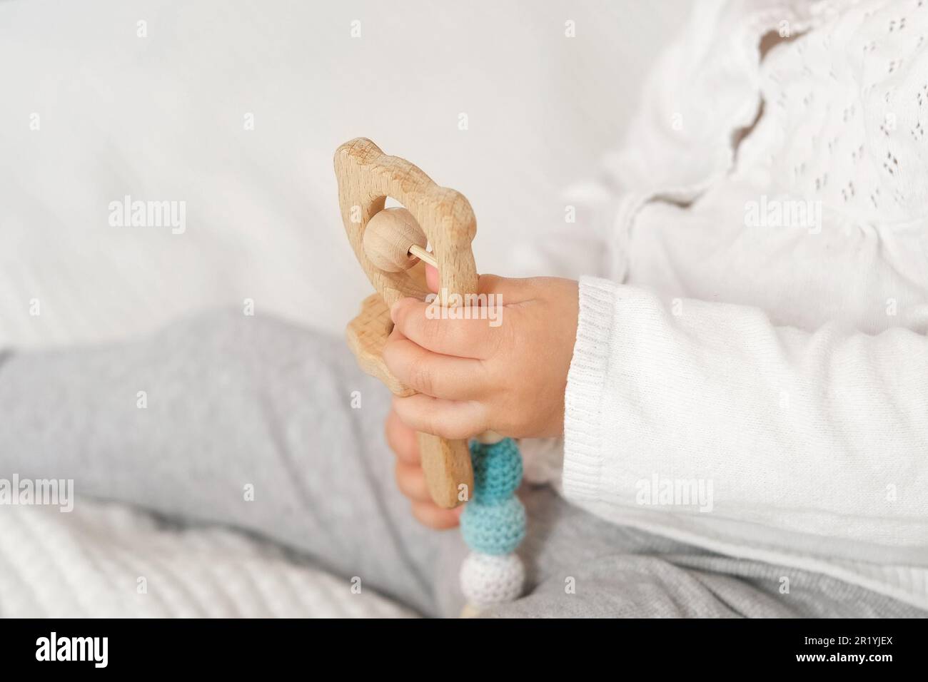 Cute baby girl playing tactile wooden and silicone toys. Young child ...