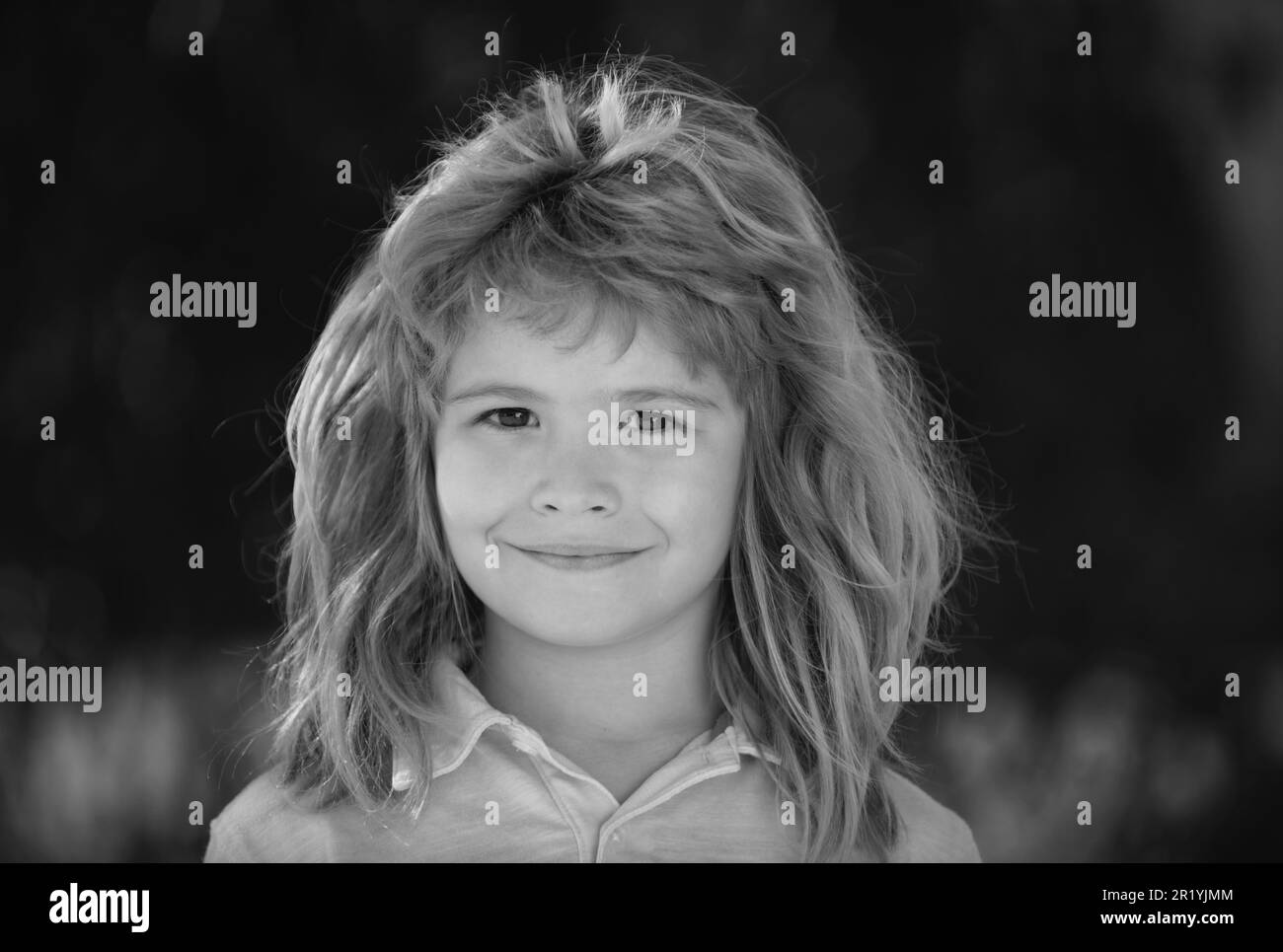 Close up portrait of cute boy smiling outdoors. Closeup headshot ...